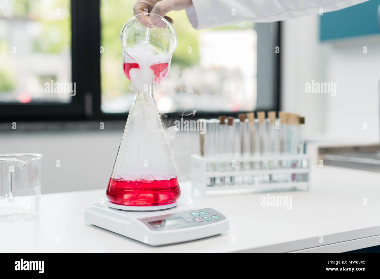 Pouring chemical into flask hi-res stock photography and images - Alamy