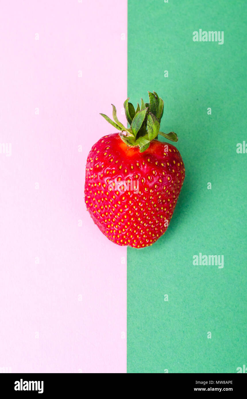One mellow red strawberry on bright background. Studio Photo Stock ...