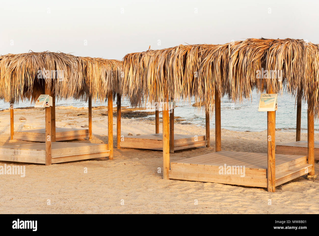 palm thatch bed shade on the beach ready for summer holiday Stock Photo ...