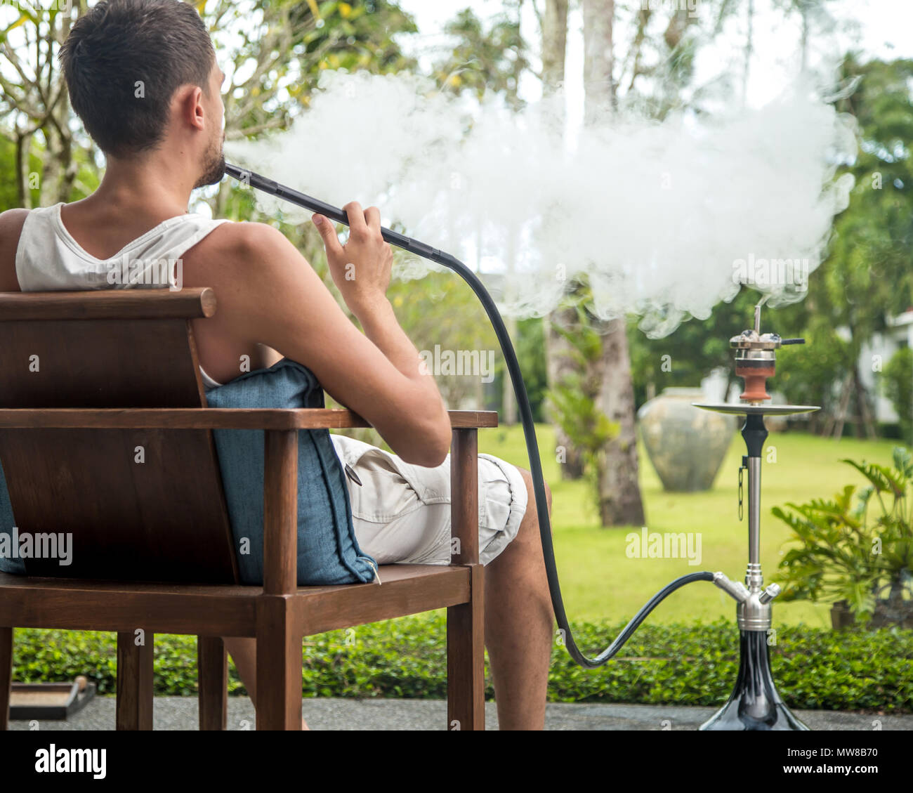 man smoking a hookah on vacation background lifestyle concept Stock ...