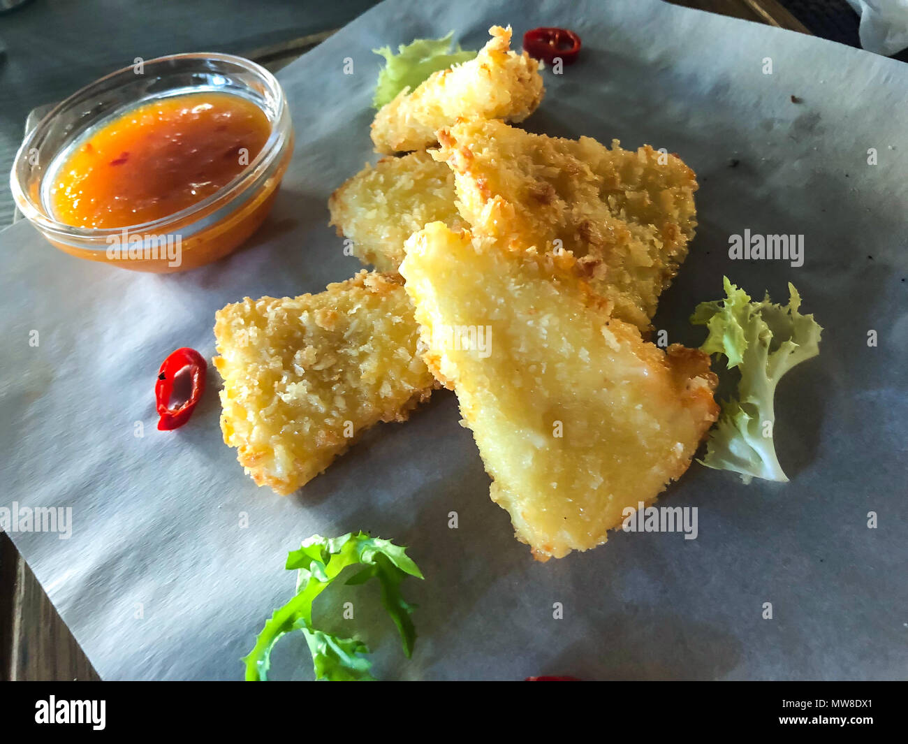 Fried slices of deep-fried cheese, hot sauce Stock Photo - Alamy