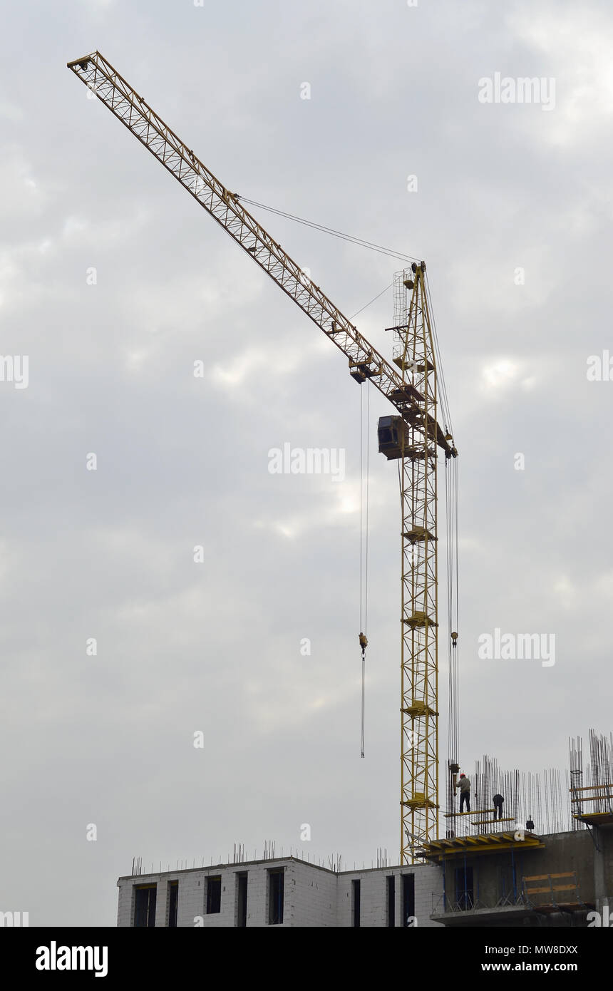 Working tall cranes inside place for with tall buildings under ...