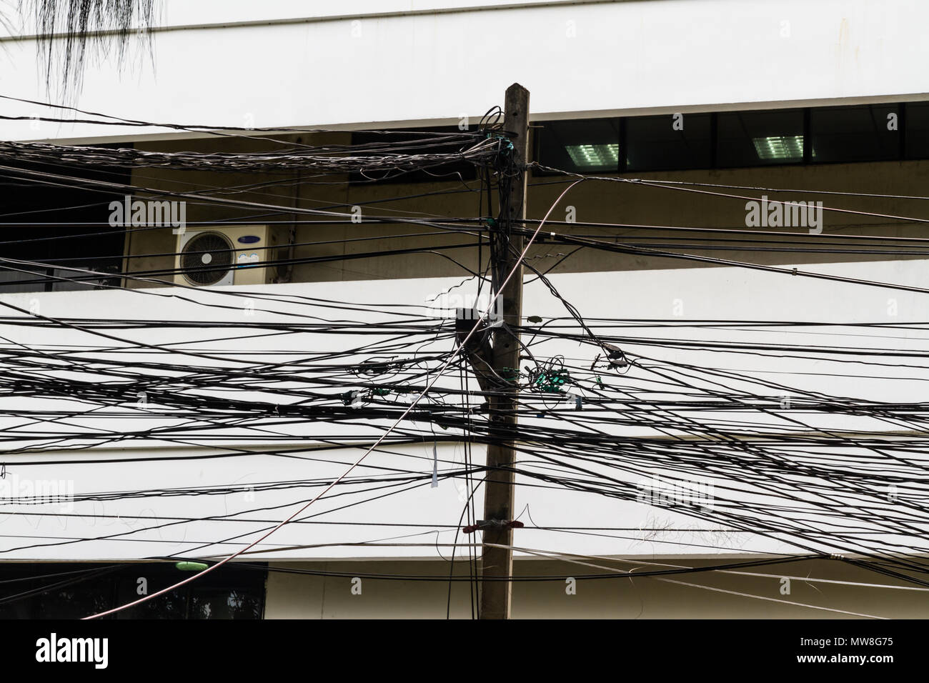 Telegraph or electric pole with tangle of wires or cables Stock Photo ...