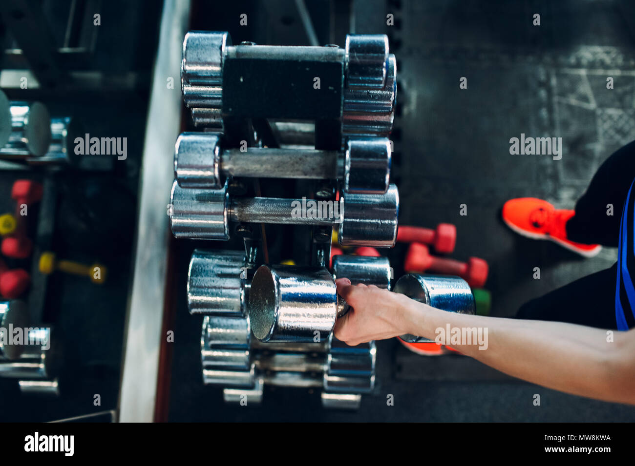 Hand and dumbbells. Fitness in gym Stock Photo - Alamy