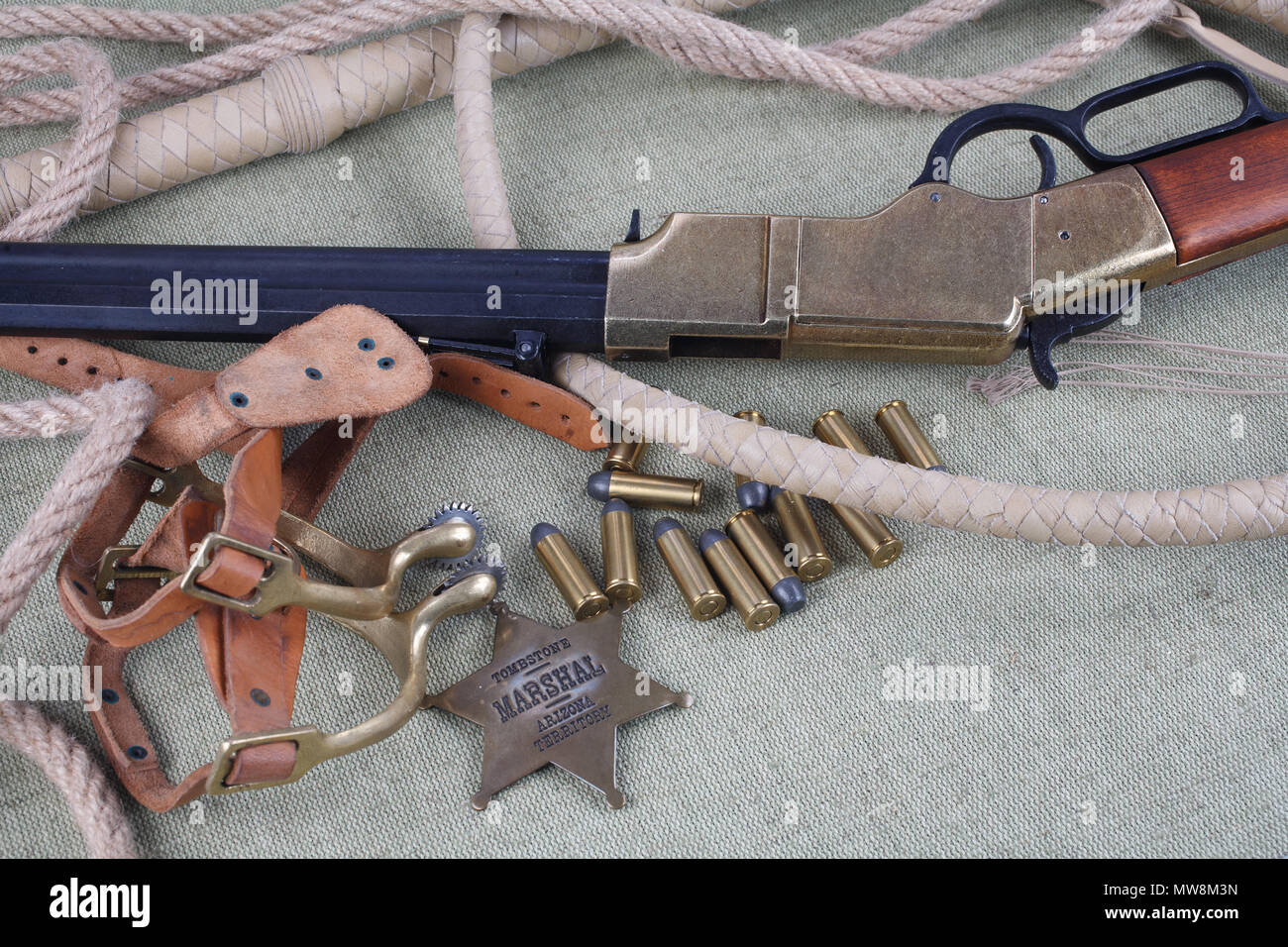Wild west period repeating rifle with ammunition and sheriff badge ...