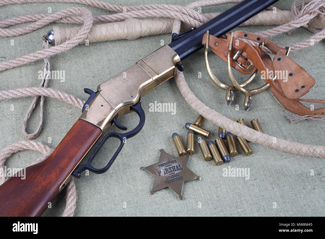 Wild west period repeating rifle with ammunition and sheriff badge ...