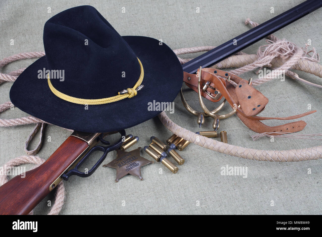 Wild west period repeating rifle with ammunition and sheriff badge ...