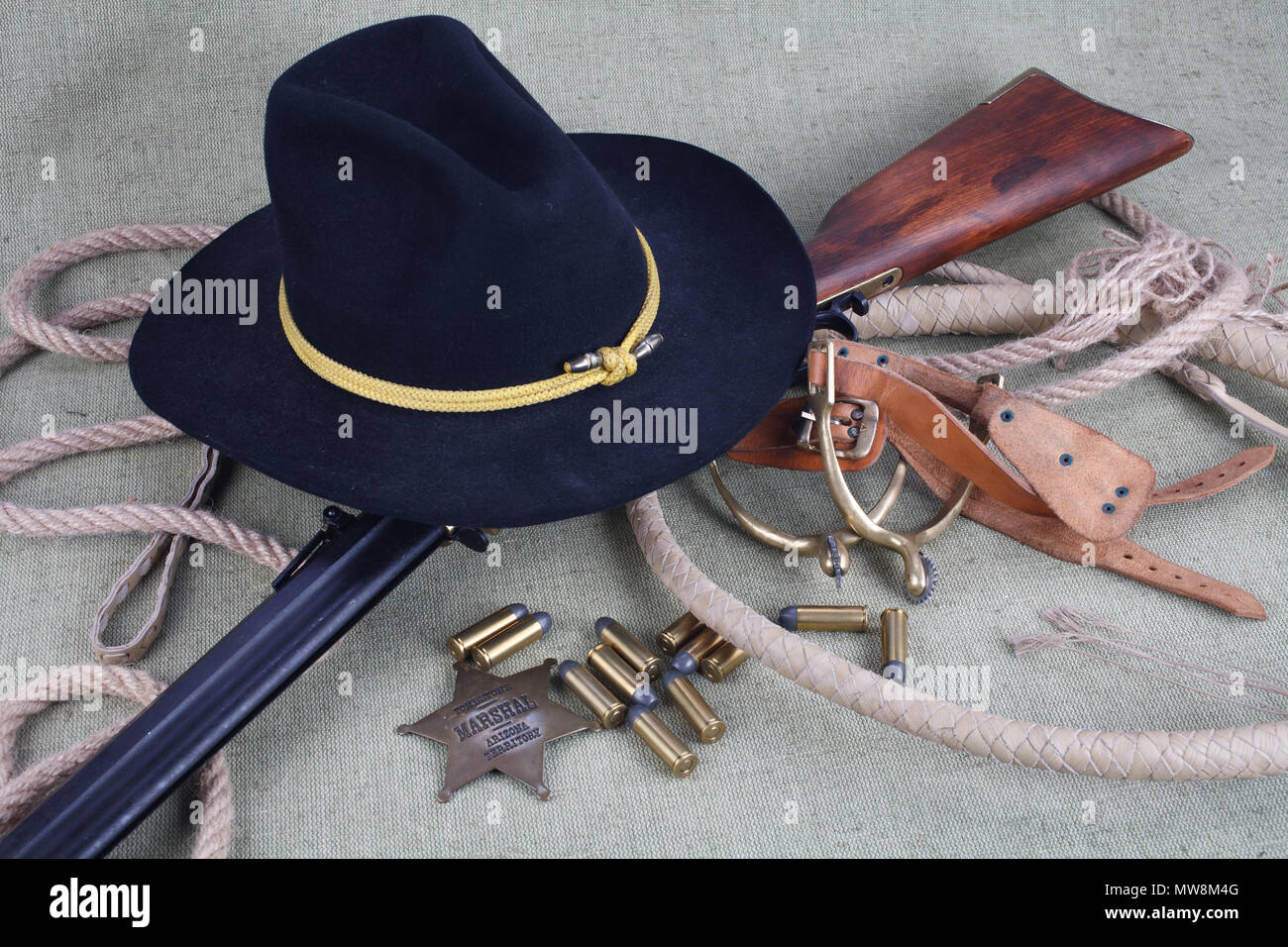 Wild west period repeating rifle with ammunition and sheriff badge ...