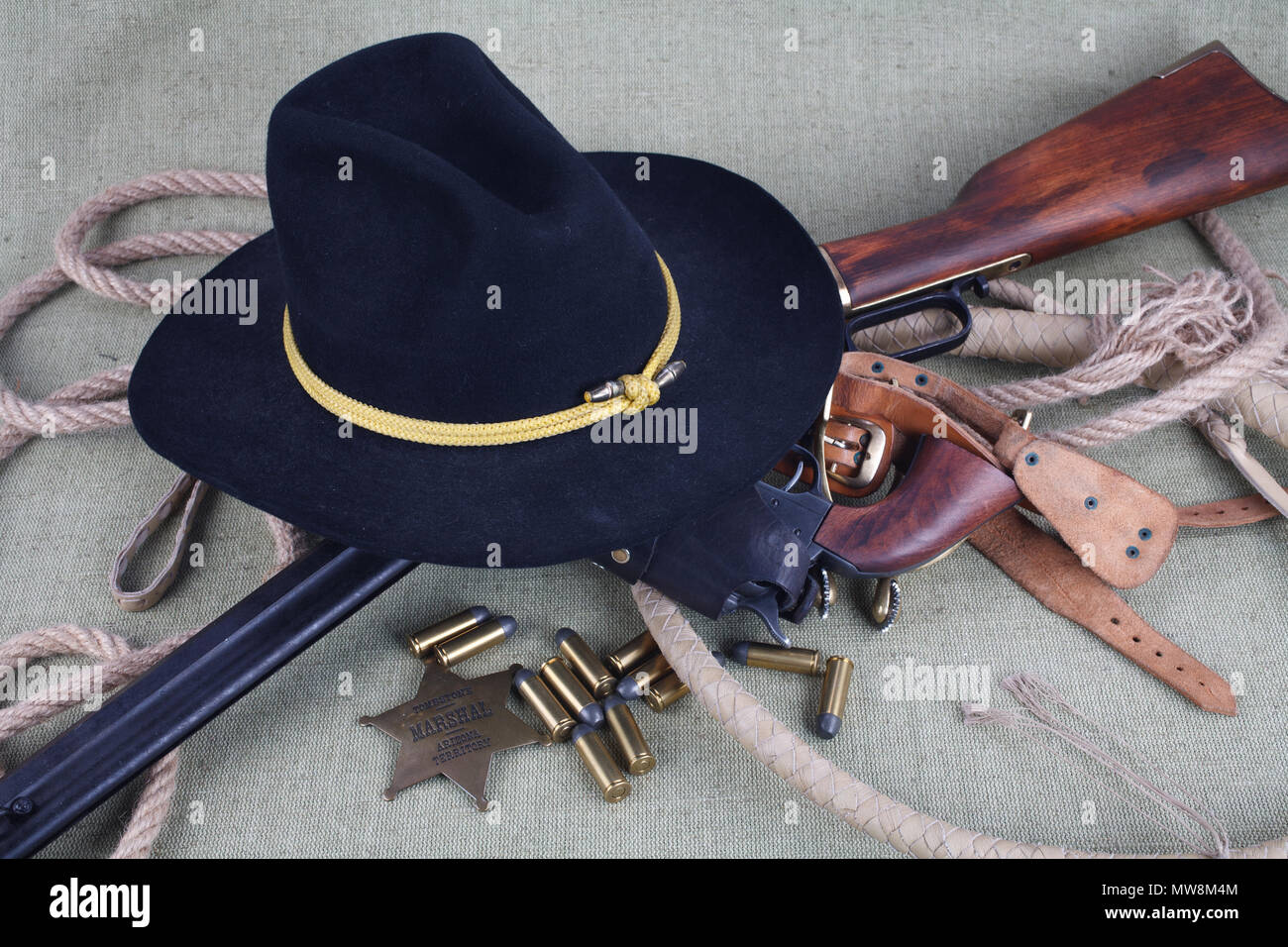 Wild west period repeating rifle with ammunition and sheriff badge ...
