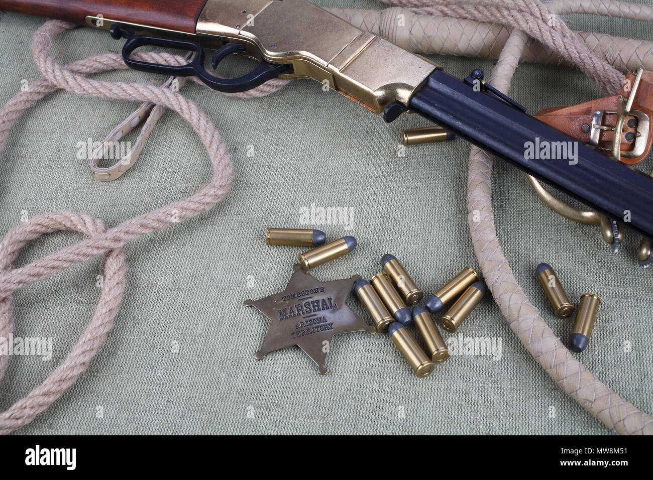 Wild west period repeating rifle with ammunition and sheriff badge ...