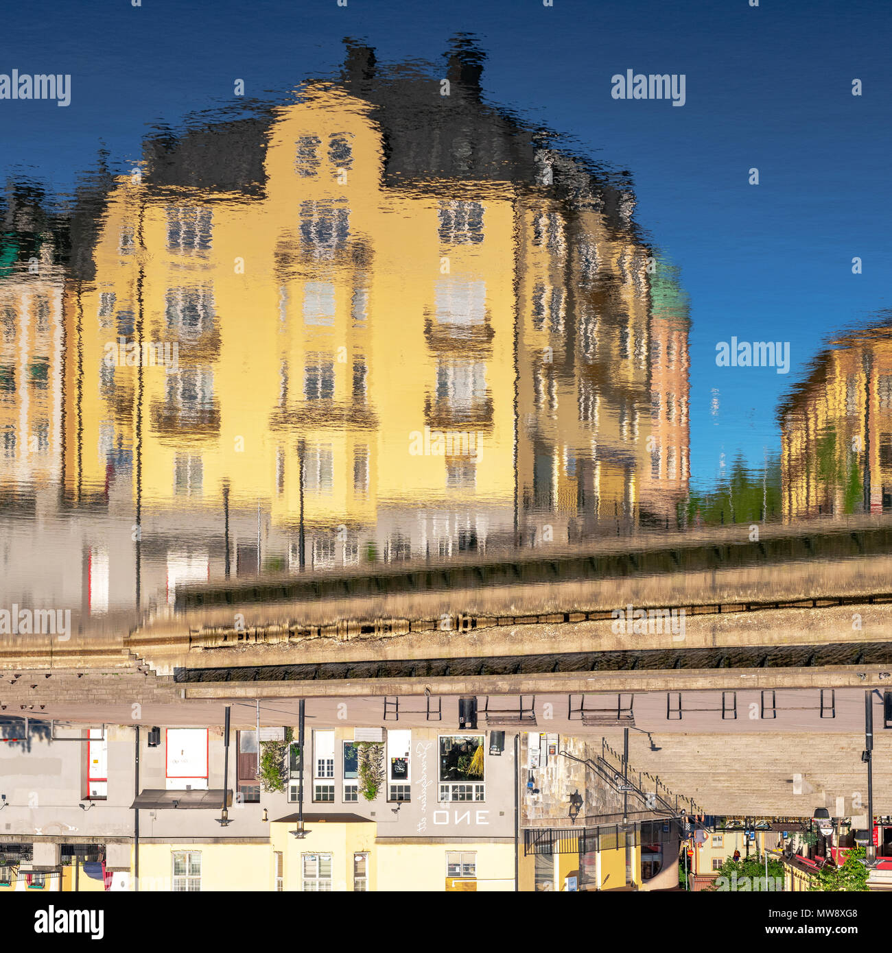 Flipped image of a house in a reflection. Square format Stock Photo - Alamy