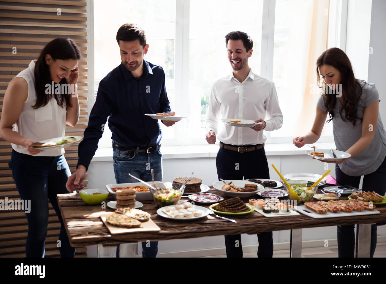 Friends Eating Healthy Food Served For Party Stock Photo - Alamy