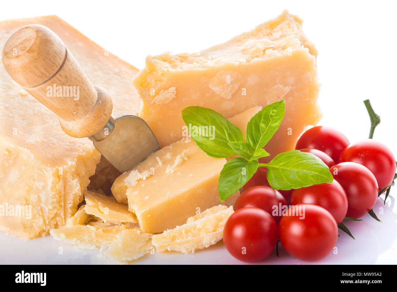 Parmesan cheese or parmigiano reggiano with cherry tomatoes and basil ...