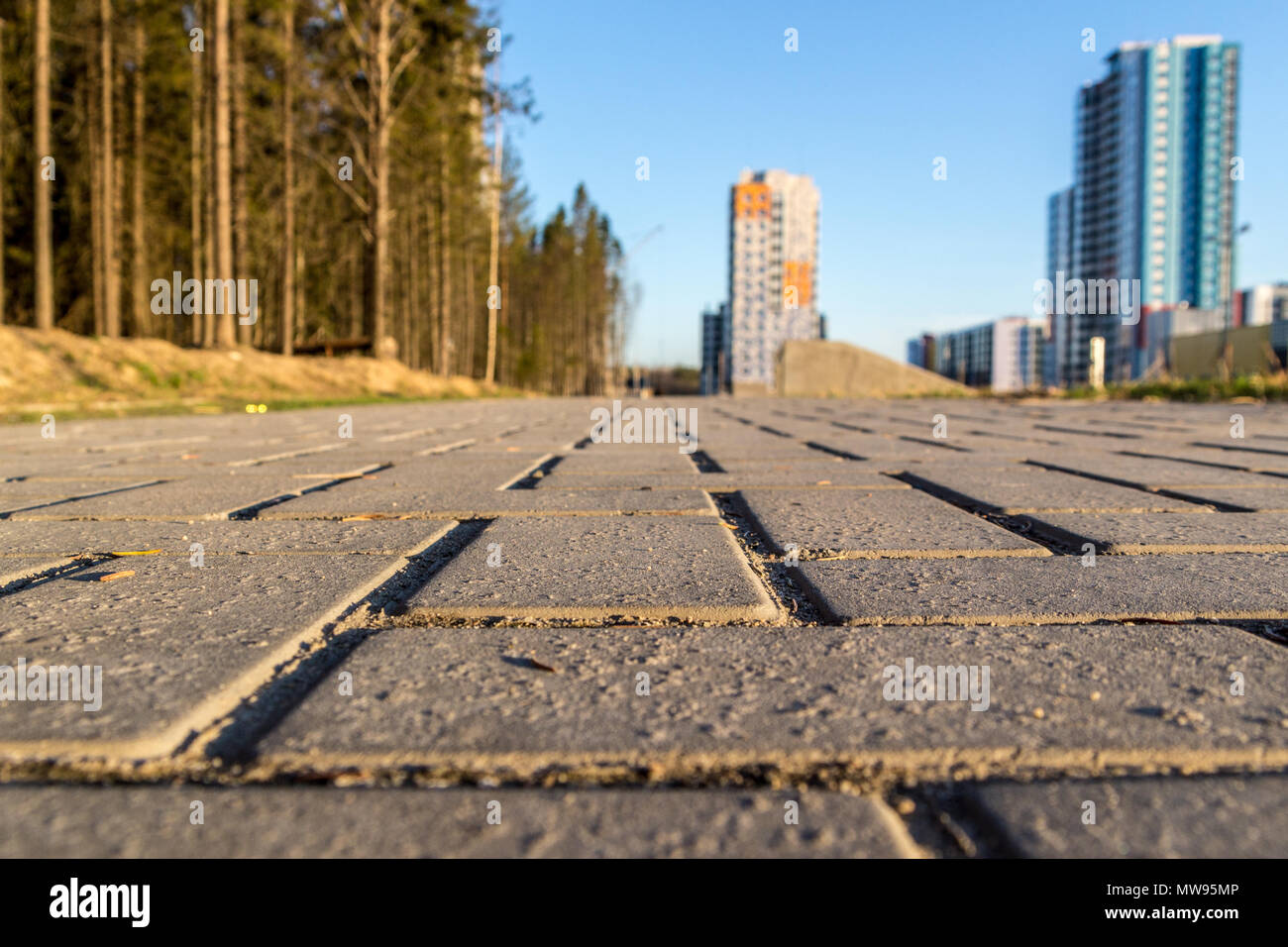 Sidewalk tile in perspective with a view of the city Stock Photo - Alamy