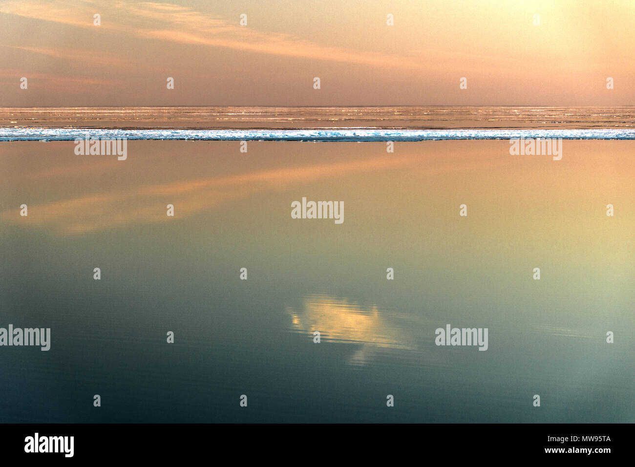 Sea surface with reflection of sky and clouds at sunset Stock Photo - Alamy