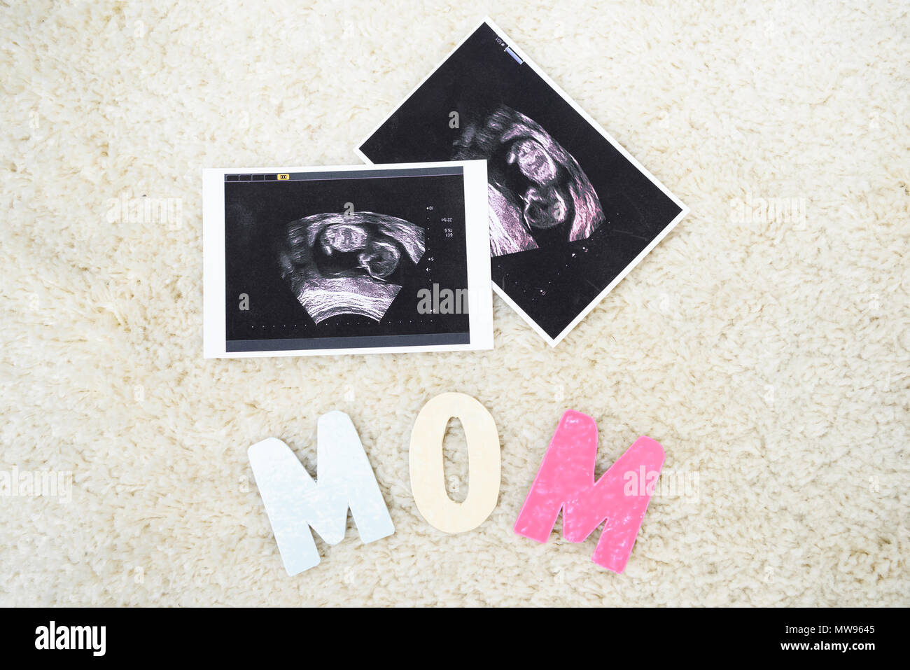top view of colorful mom word and ultrasound scans of unborn baby Stock ...