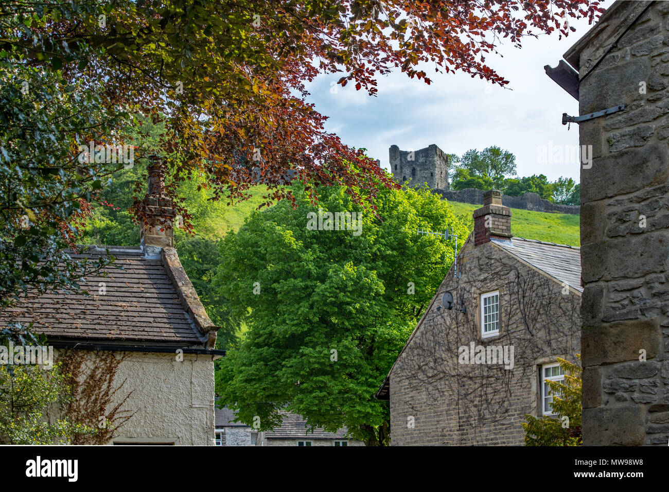 Cottages at Castleton overlooked by Peveril Castle high on the hill ...