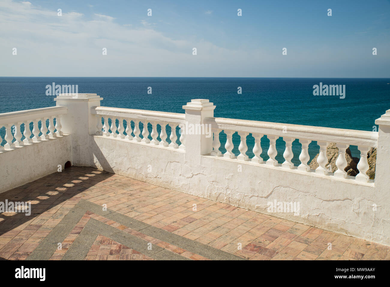 Nerja beach promenade with white balustrades against the blue ...