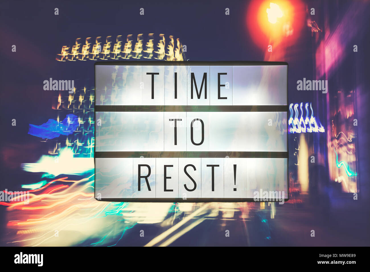 Time to Rest text in light box, motion blurred city lights in ...