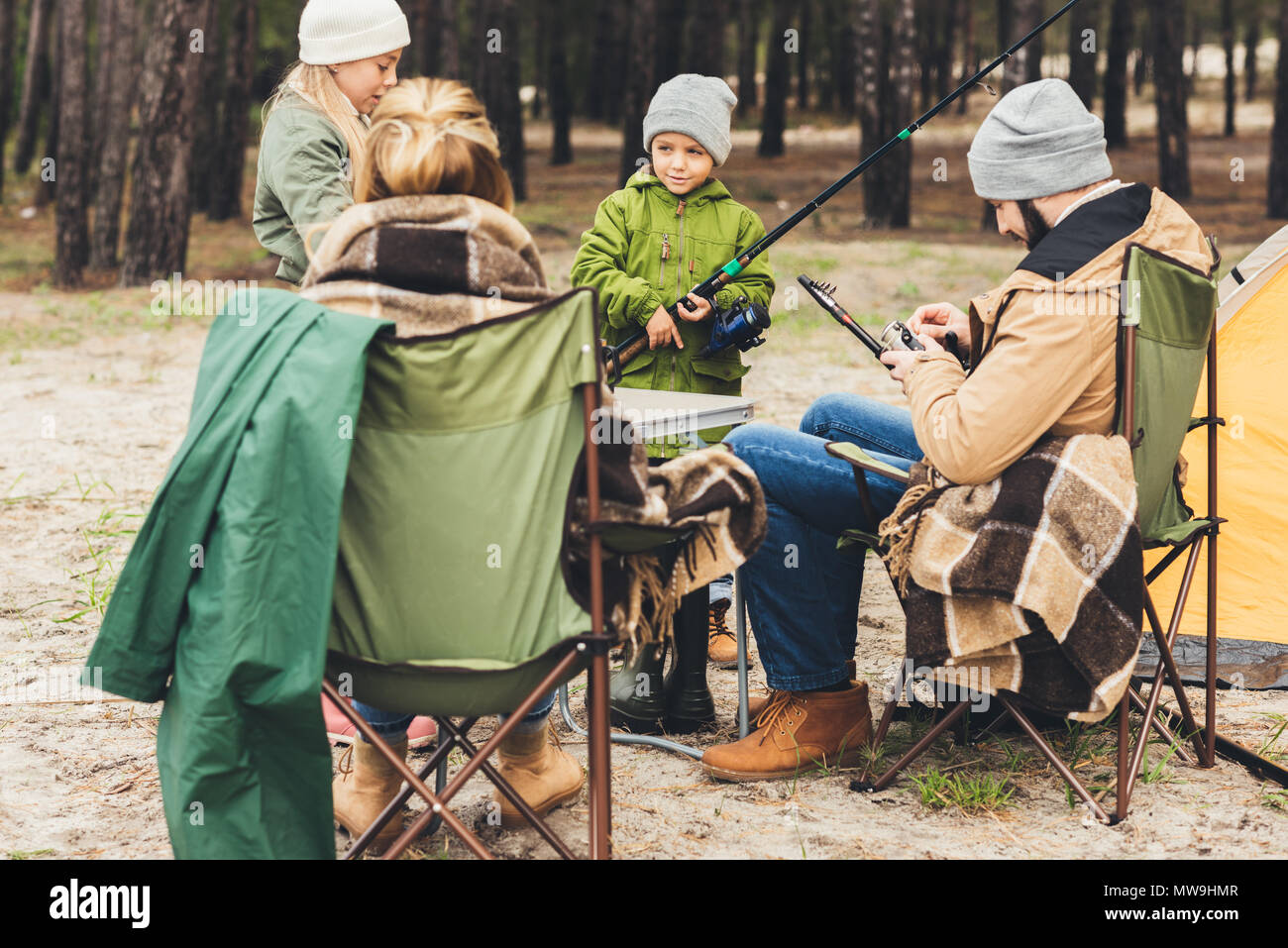 family with fishing rods on camping trip Stock Photo - Alamy