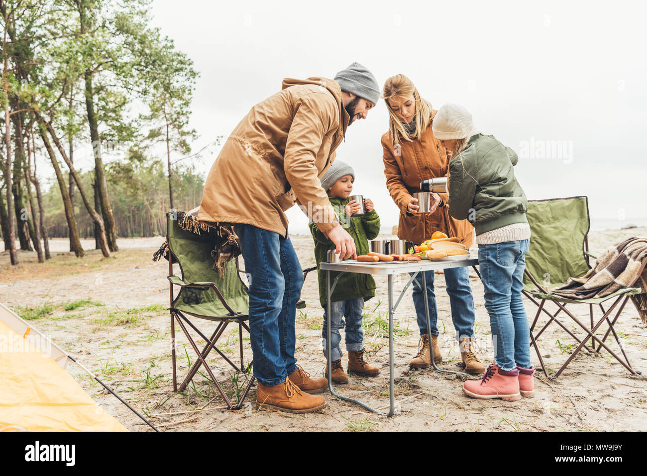 happy family having picnic on nature on cold cloudy day Stock Photo - Alamy