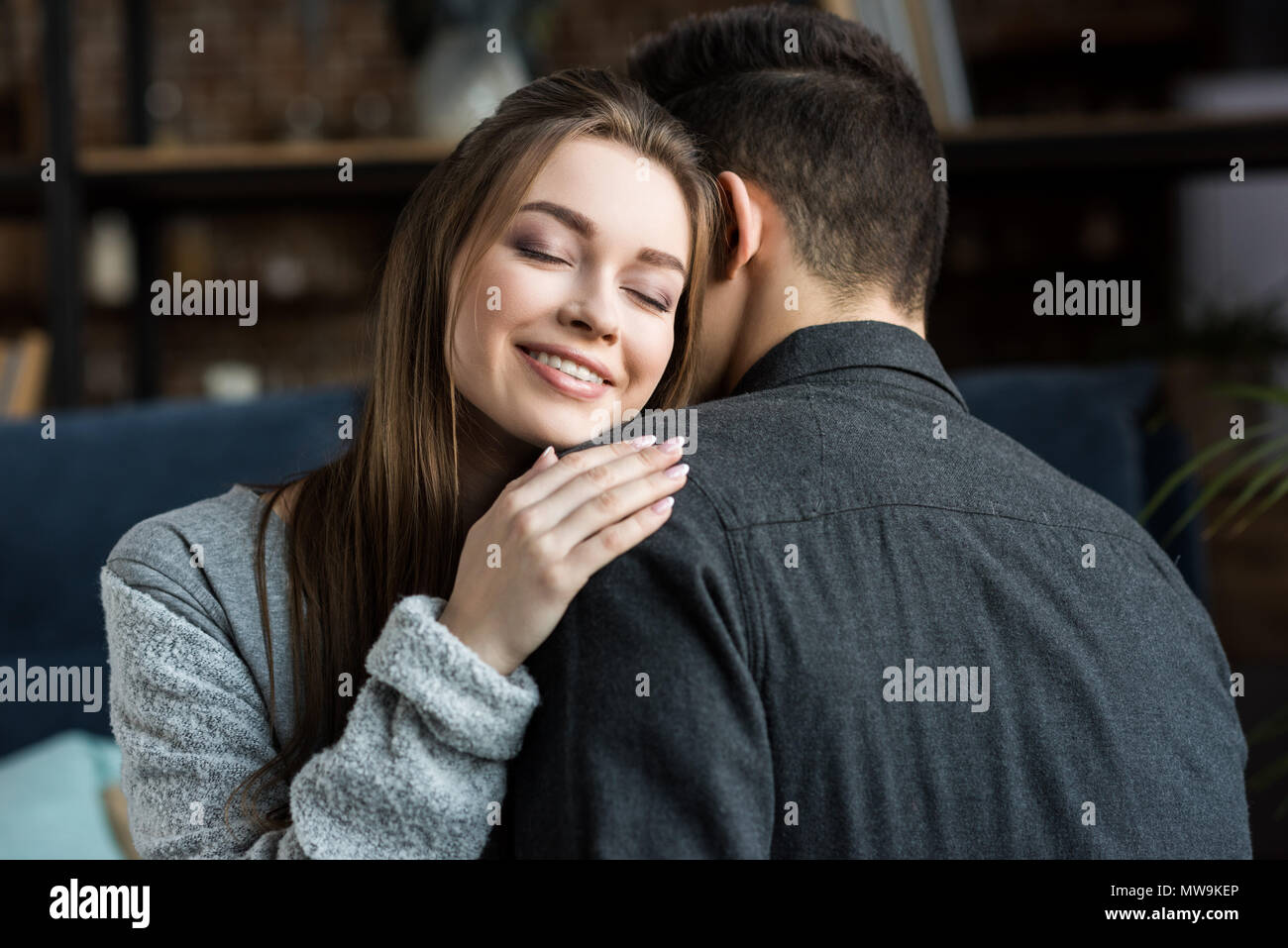 happy girlfriend hugging boyfriend with closed eyes Stock Photo - Alamy