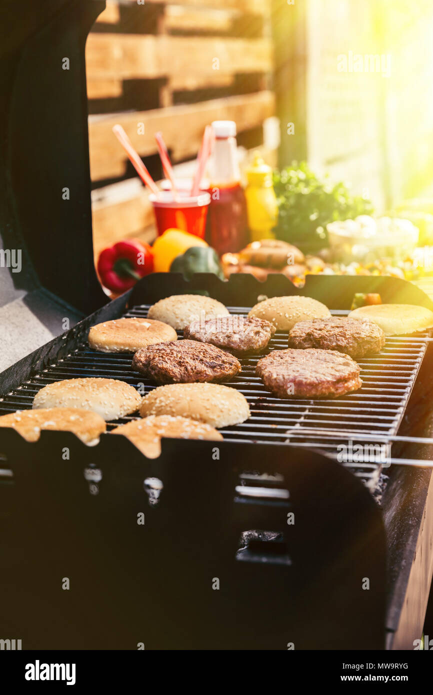 Buns and meat chops cooked outdoors on grill Stock Photo - Alamy