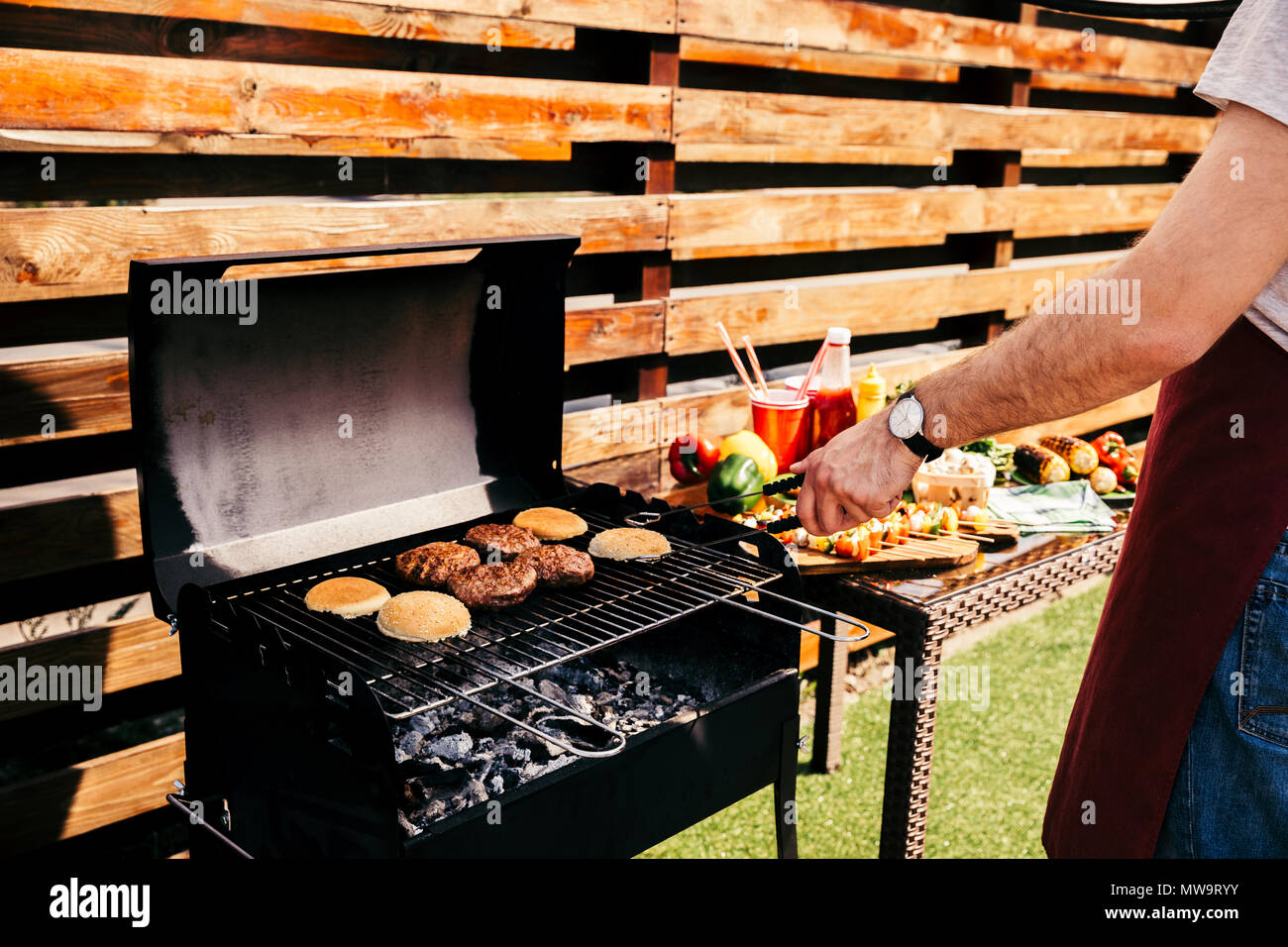 Barbecue cooking man burgers hi-res stock photography and images - Alamy