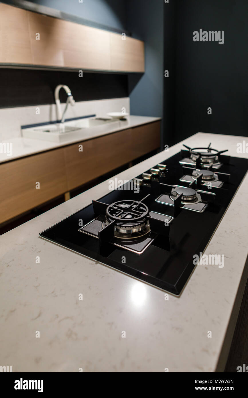 Stylish kitchen with with elegant shiny table and stove Stock Photo - Alamy