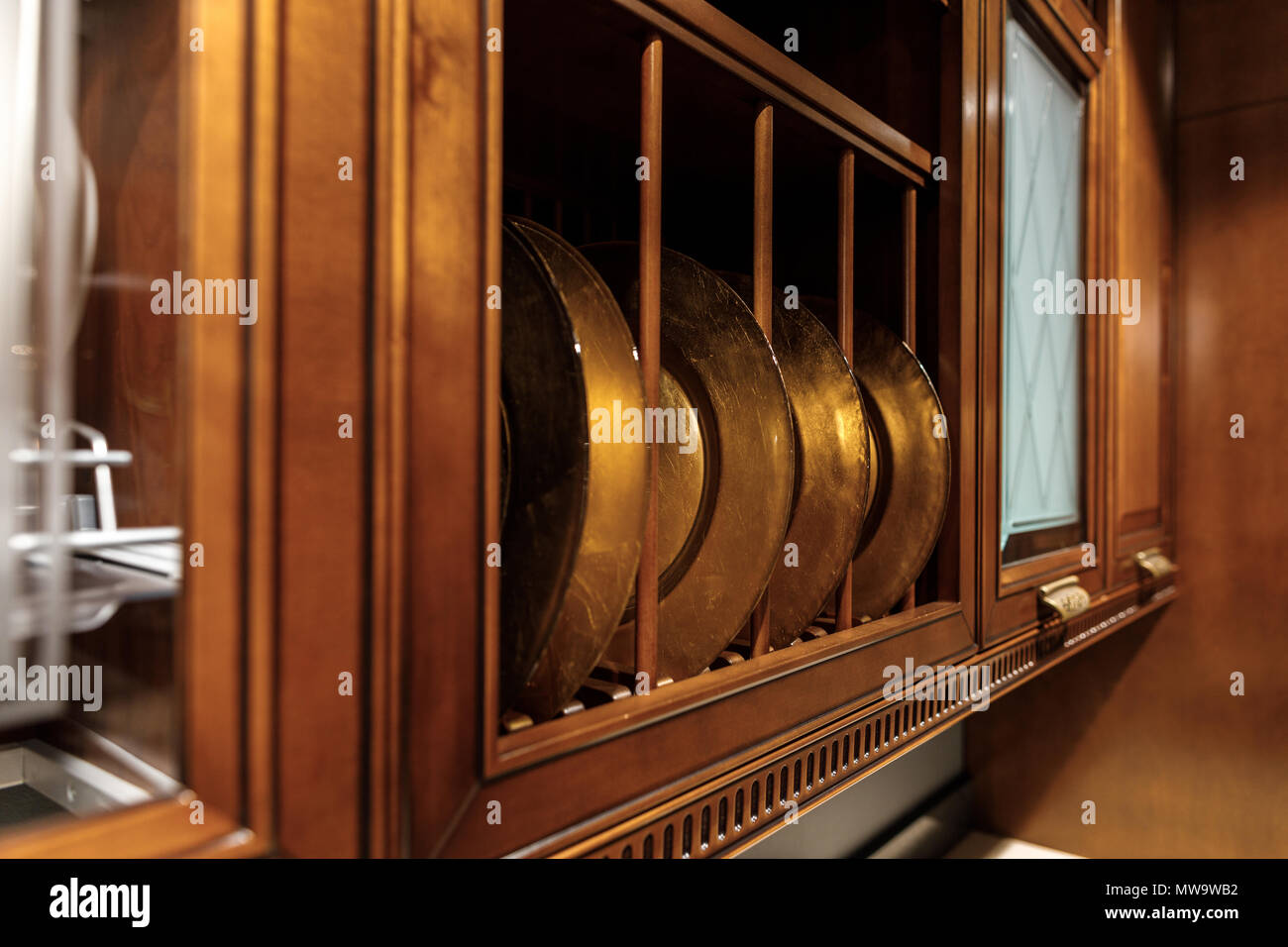 Stylish kitchen with metal plates in cupboard Stock Photo - Alamy