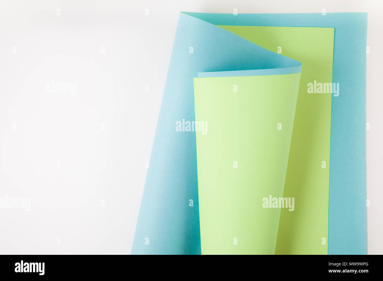 blue and green paper sheets on grey background Stock Photo - Alamy