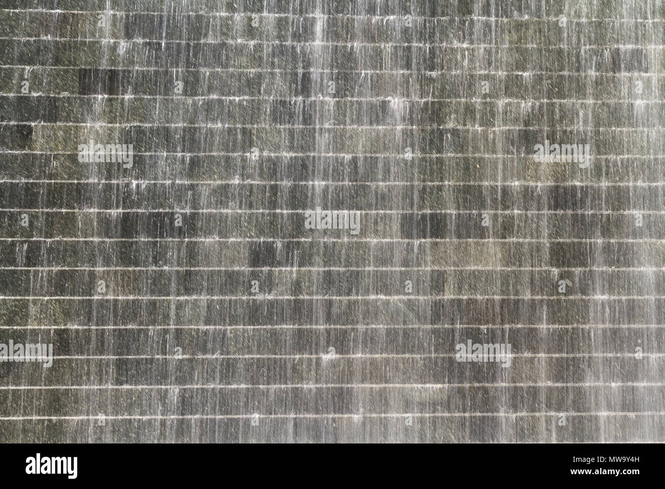 Brick background with water flowing down over it Stock Photo - Alamy
