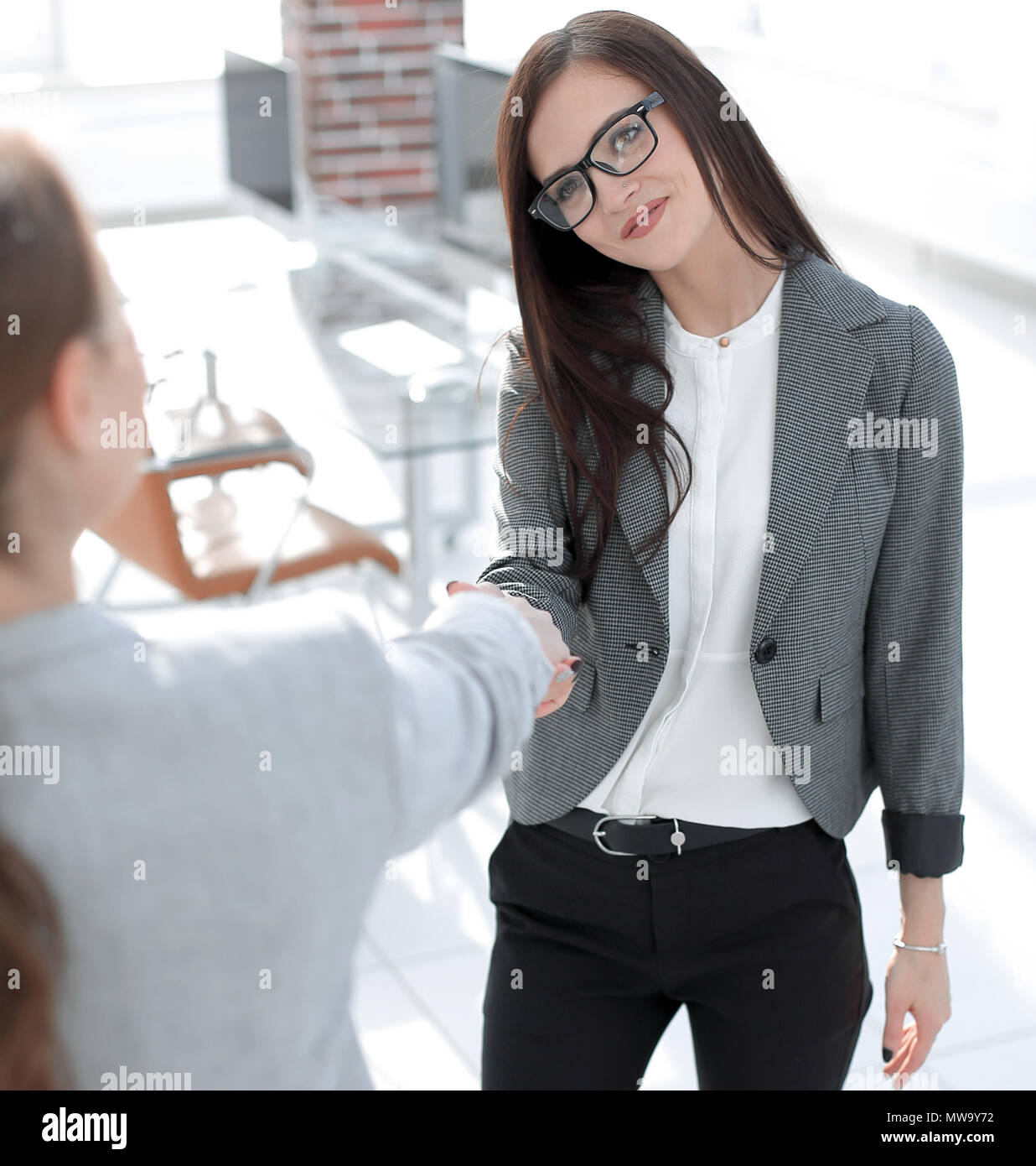 business woman meets the client with a handshake Stock Photo - Alamy