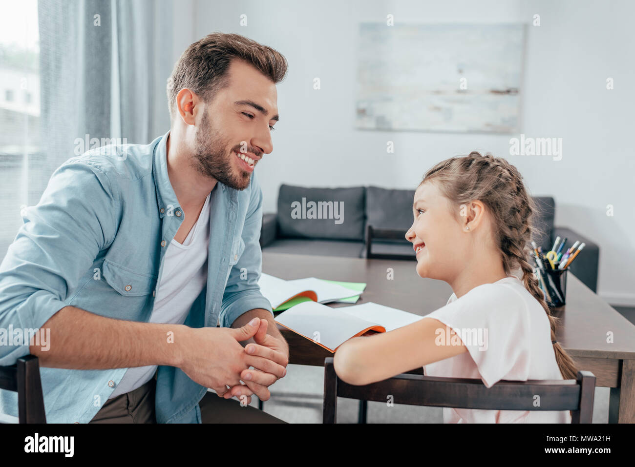 young father doing homework with little daughter Stock Photo - Alamy