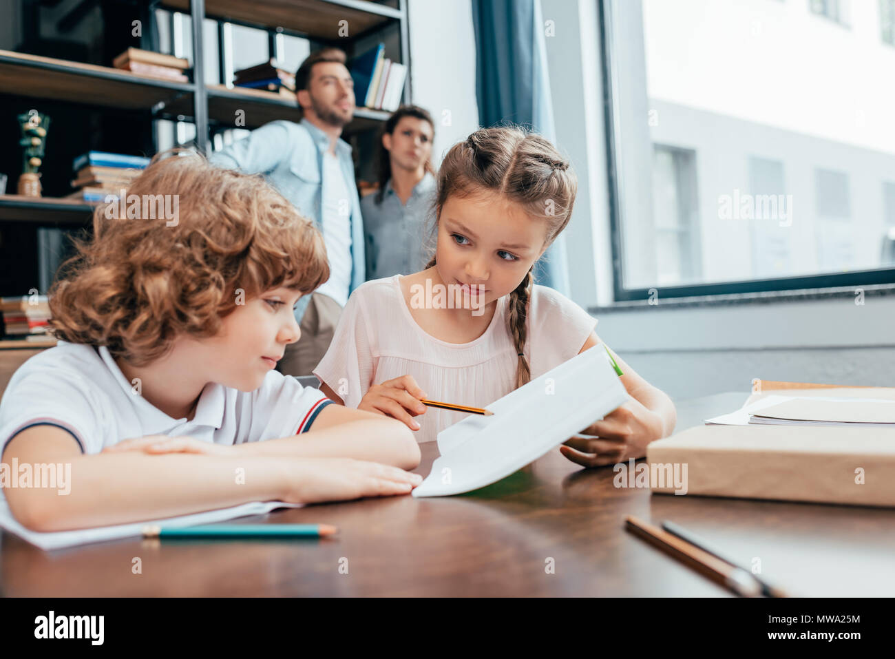 beautiful little kids doing homework together Stock Photo - Alamy