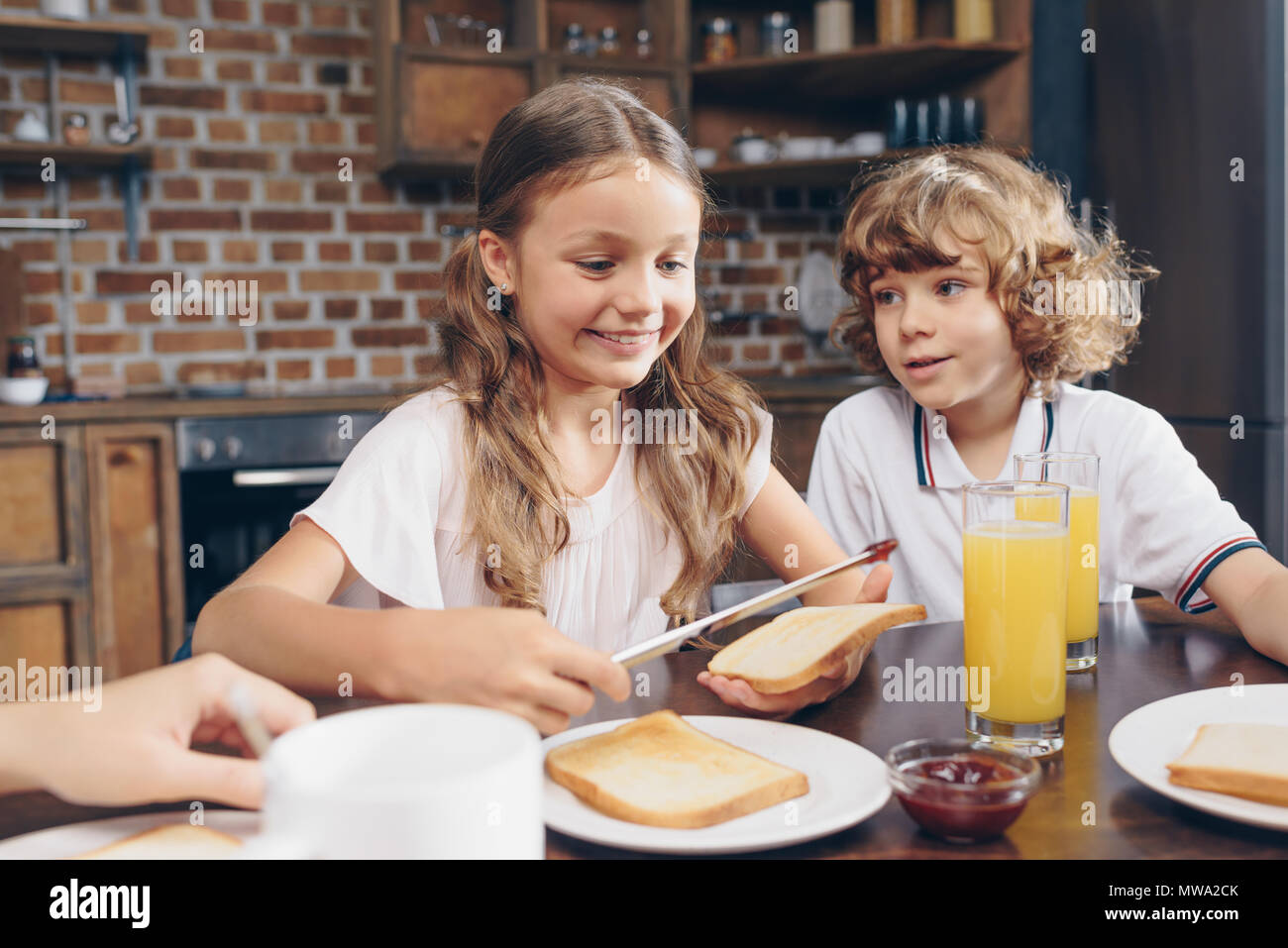 happy little kids having breakfast before school Stock Photo - Alamy