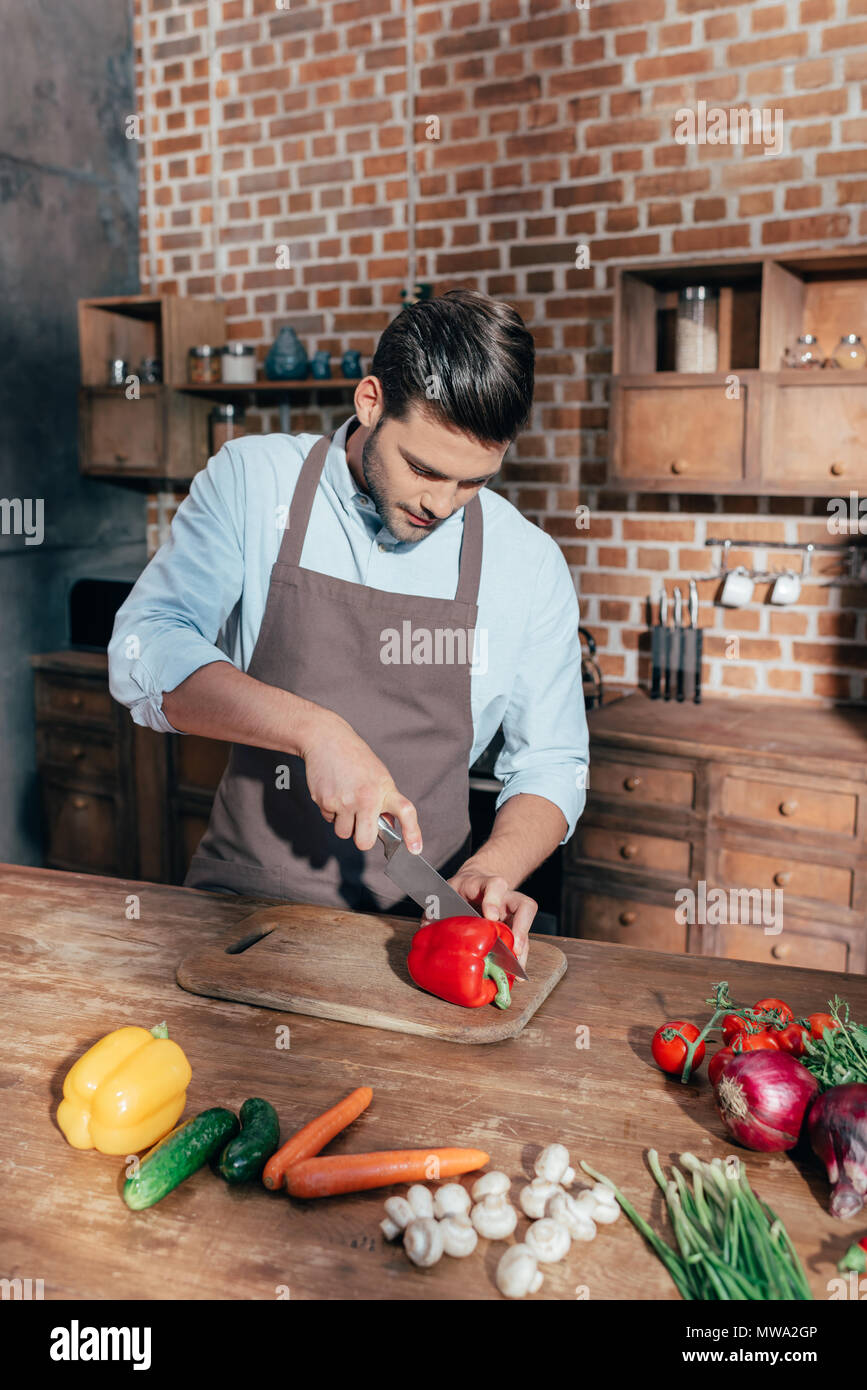 Handsome man slicing vegetables hi-res stock photography and images - Alamy
