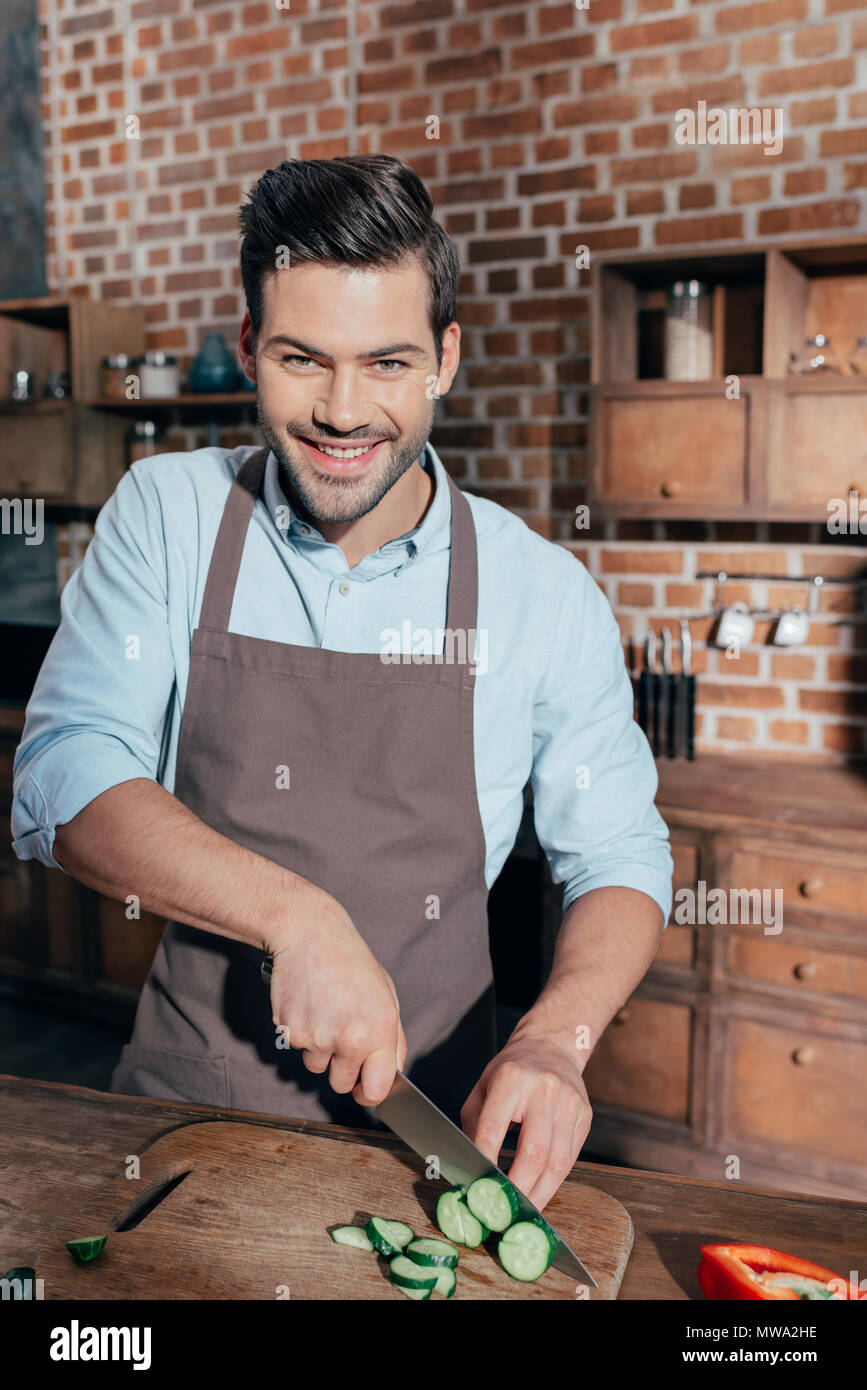 Handsome man slicing vegetables hi-res stock photography and images - Alamy