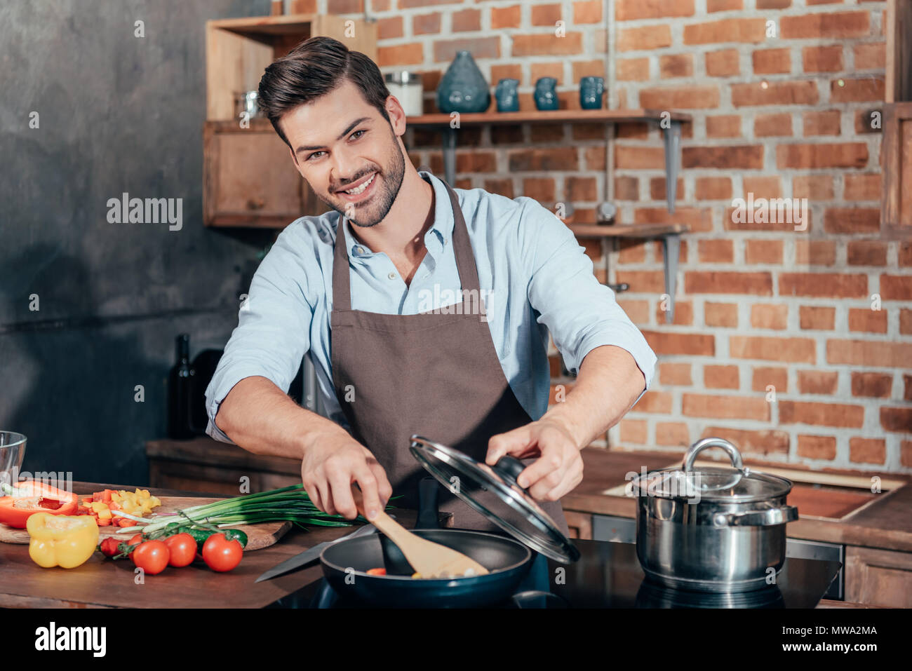 happy handsome man with apron cooking Stock Photo - Alamy