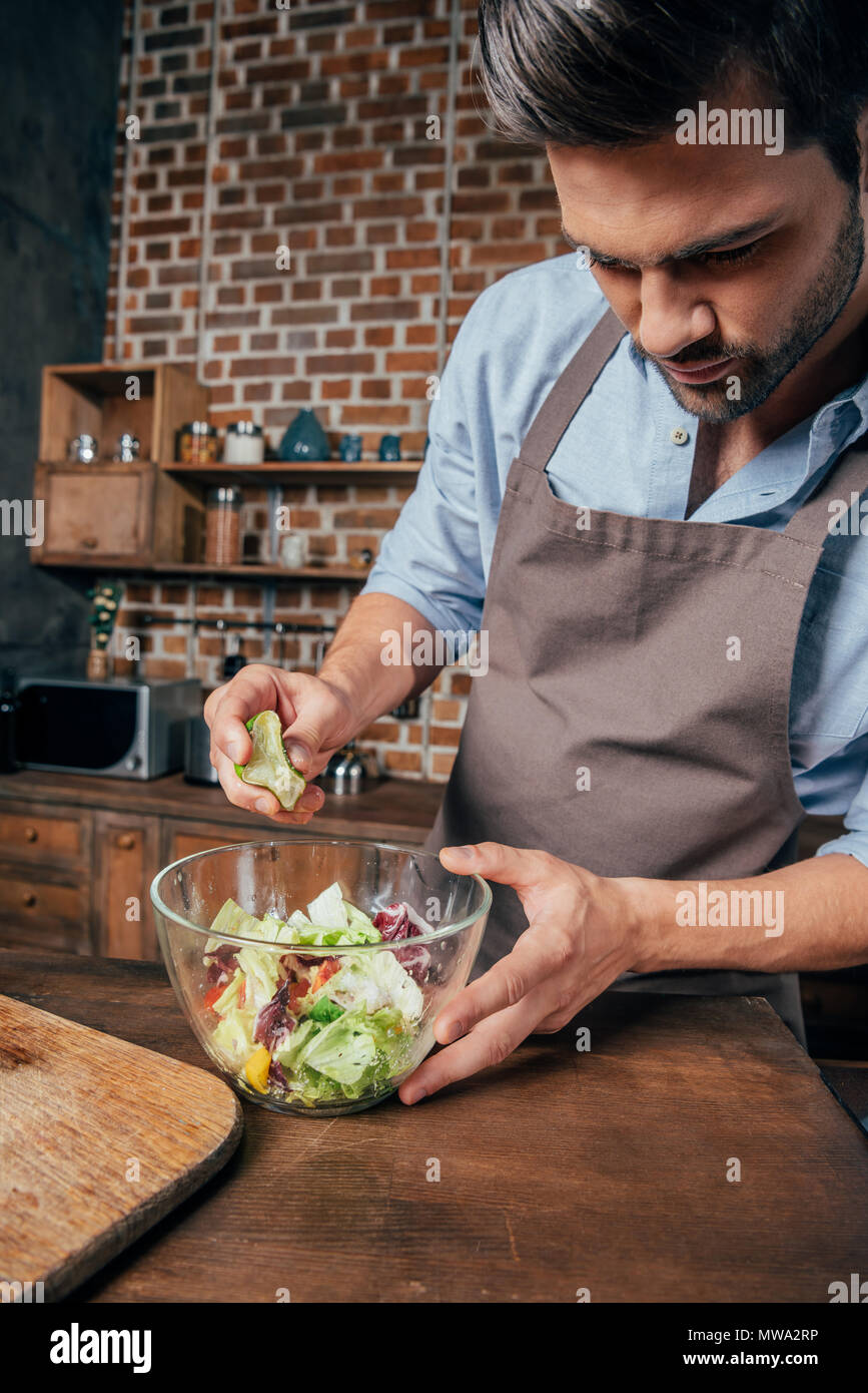 passionated young man making salad Stock Photo - Alamy