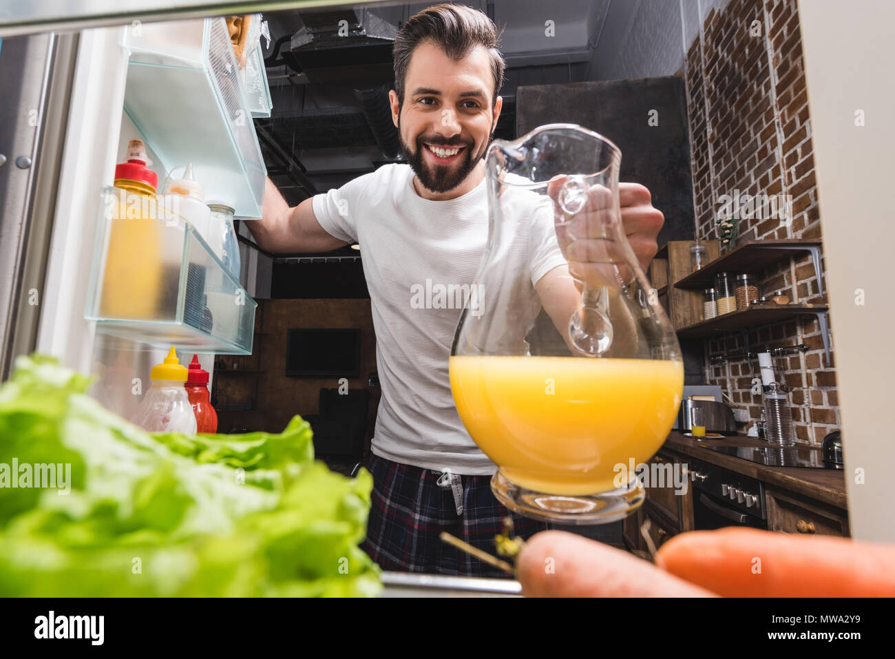 Man taking drink out of fridge hi-res stock photography and images - Alamy