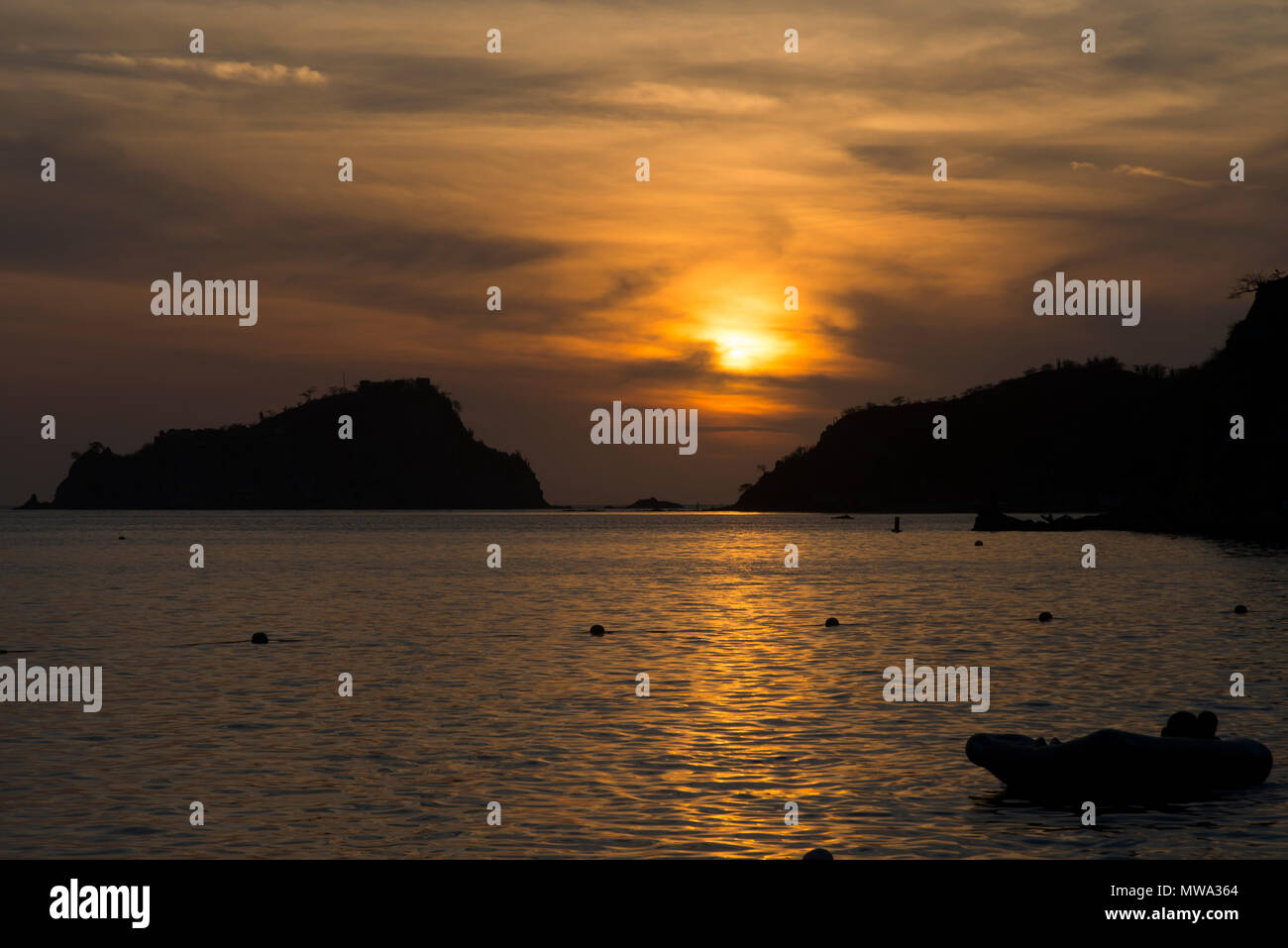 Sunset at the beach with people Stock Photo - Alamy