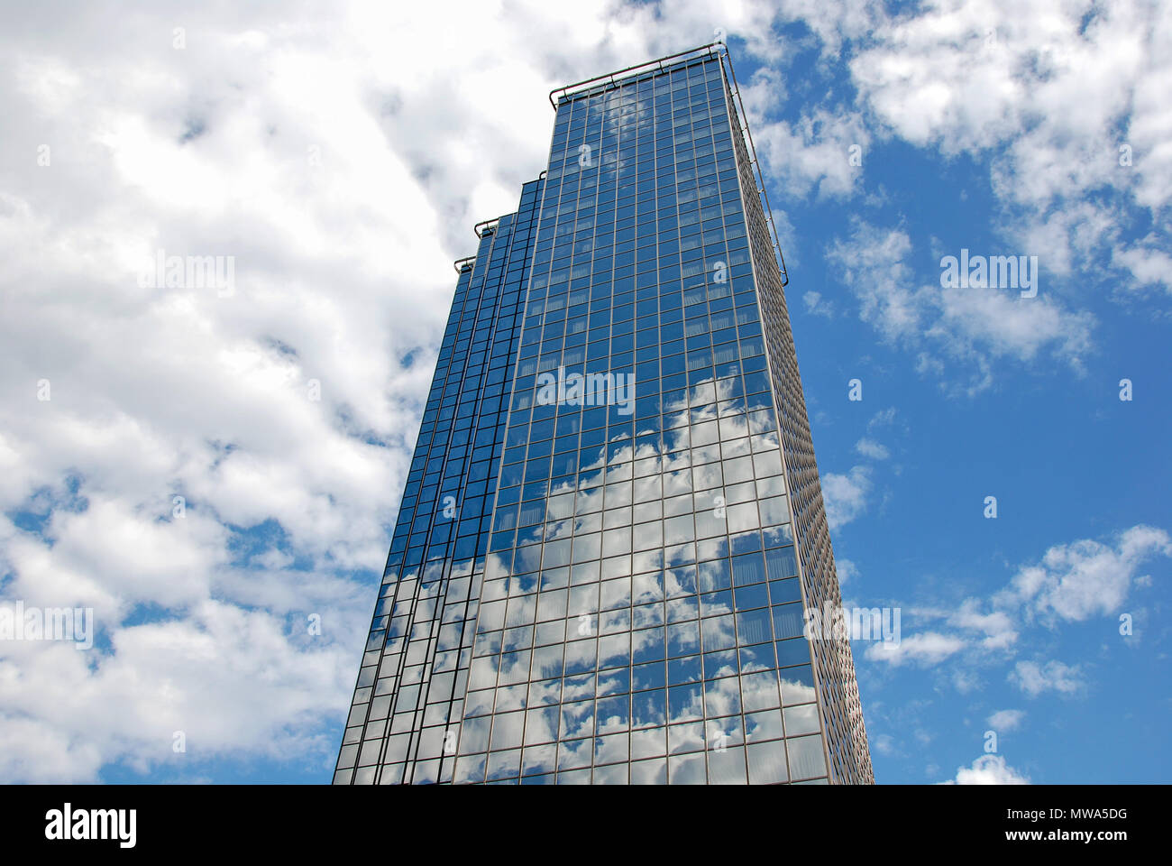 white cloud and blue sky reflected in glass skyscraper in Grand Rapids ...