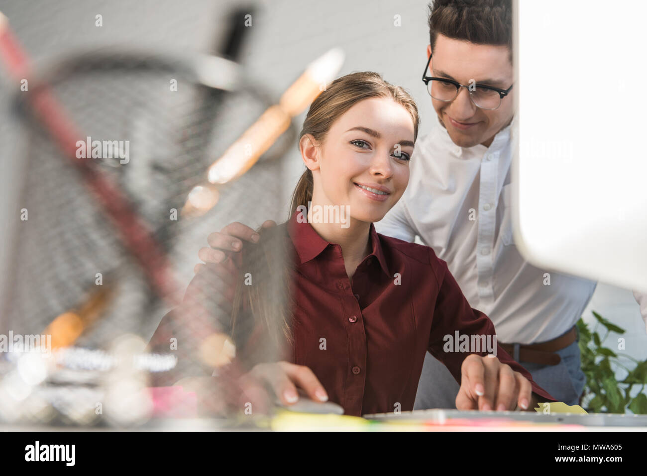 young handsome businessman flirtling with female colleague at office ...