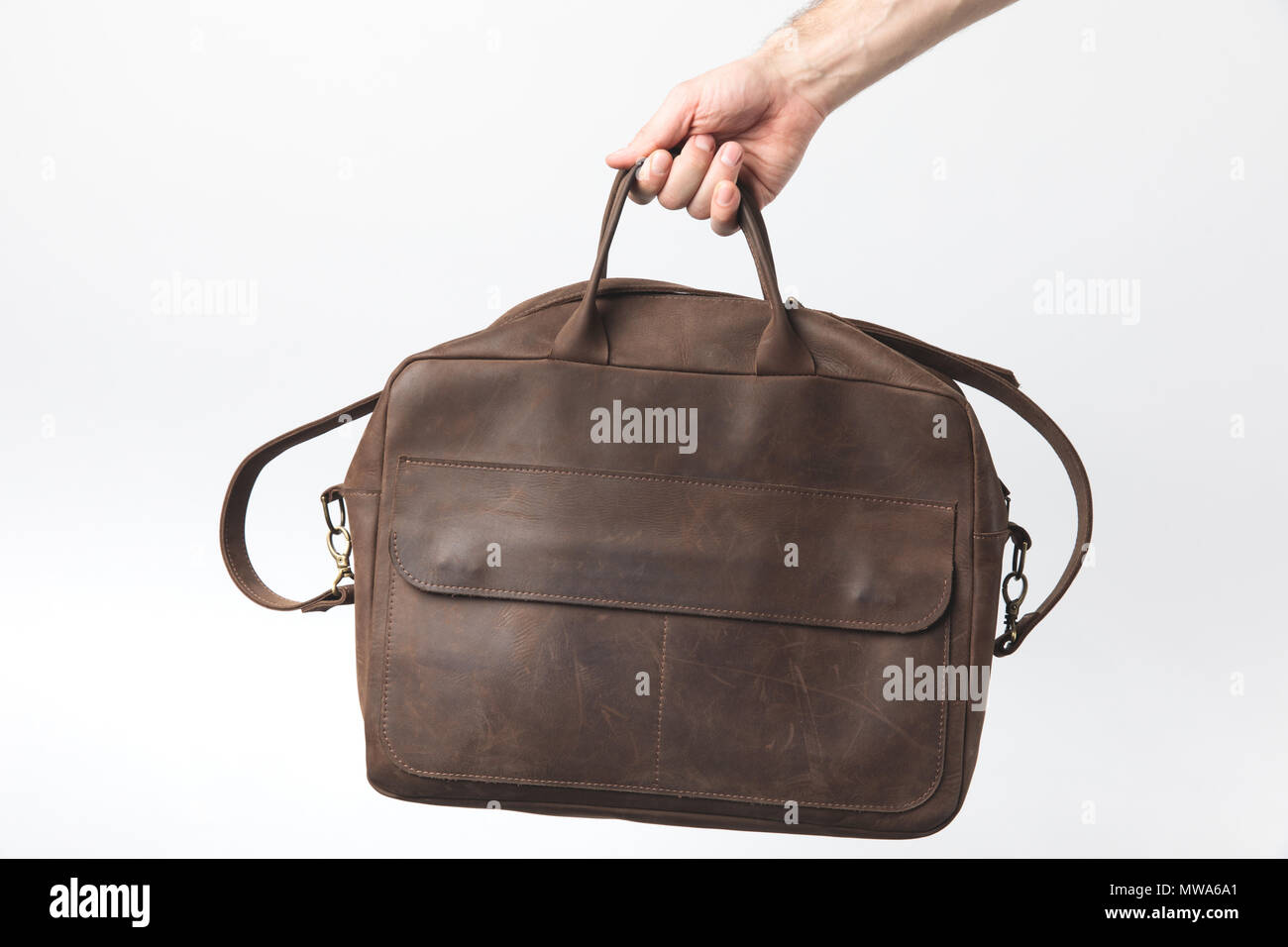 partial view of man holding stylish bag in hand isolated on white Stock ...