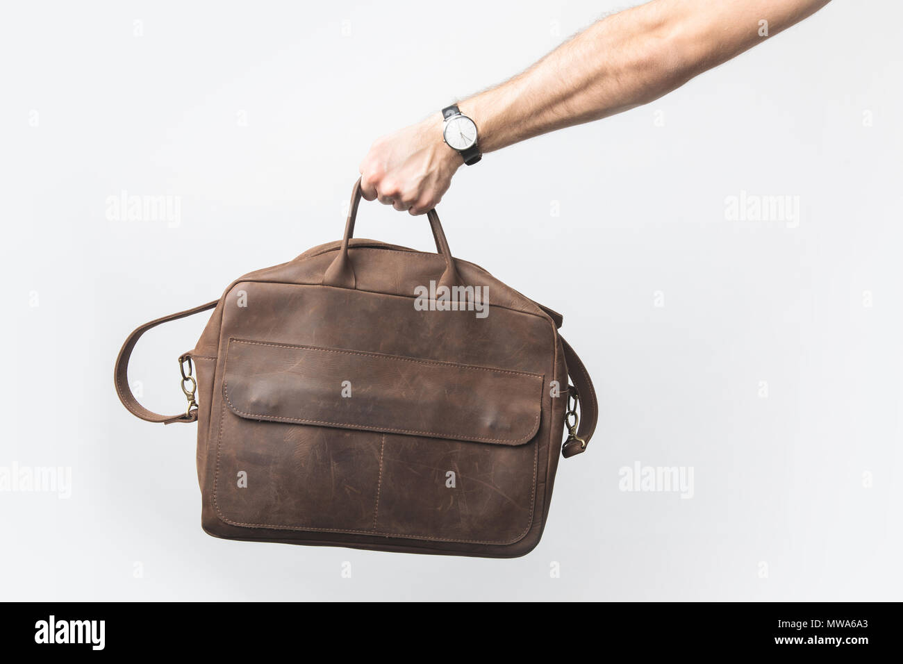 partial view of man holding leather bag in hand isolated on white Stock ...