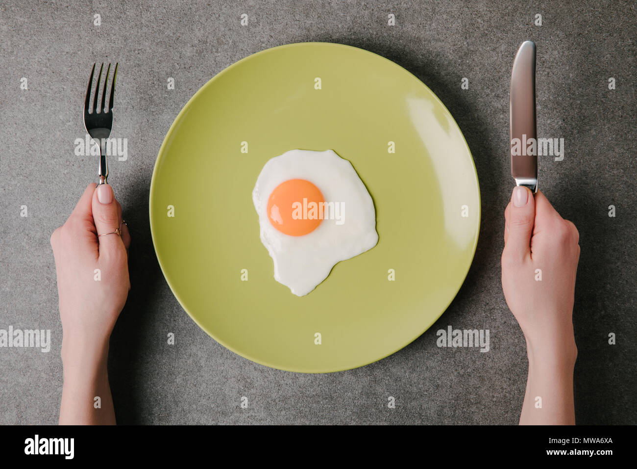 cropped shot of person holding fork and knife ready to eat tasty fried ...
