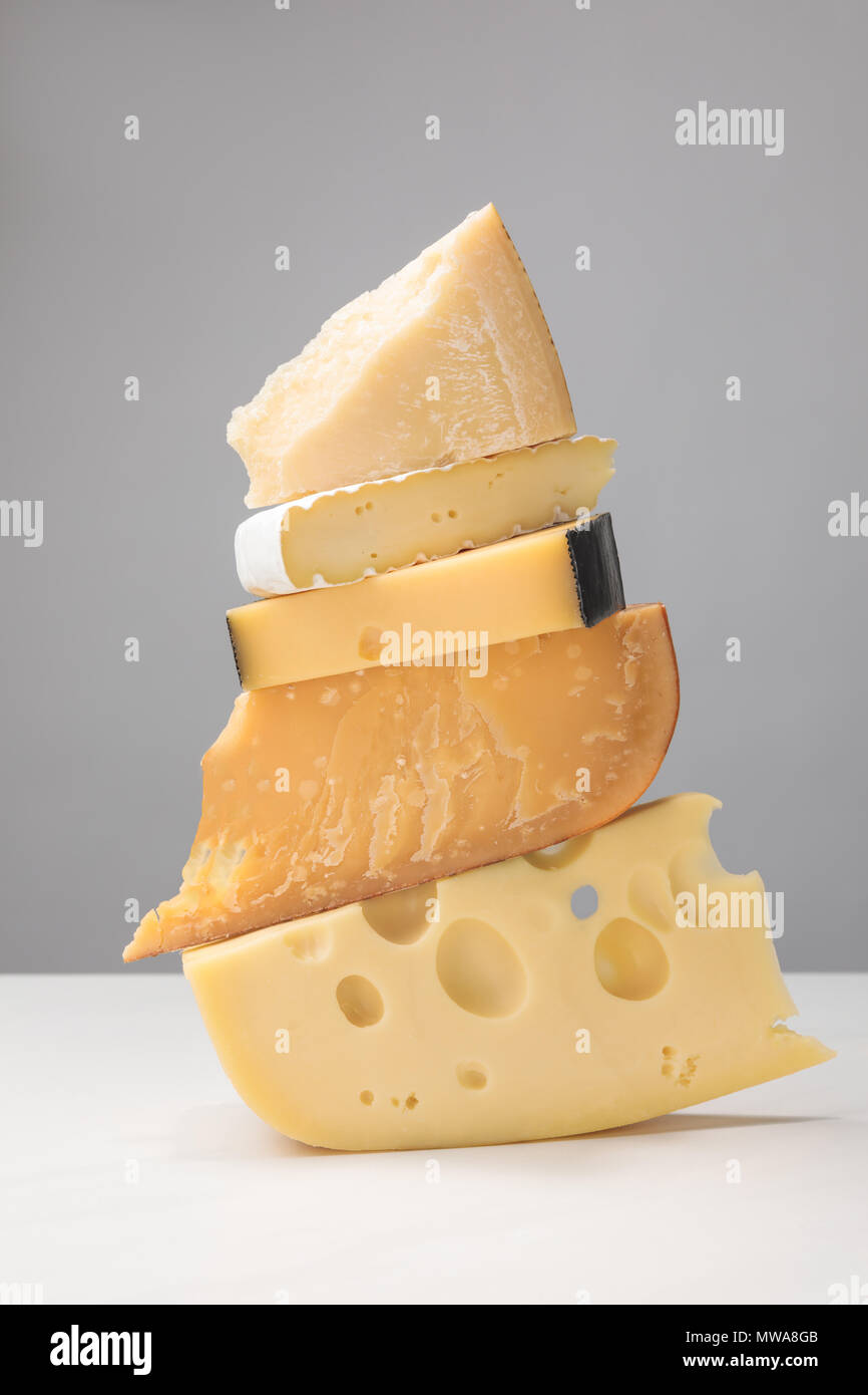 Close up view of stack of different types of cheese on gray Stock Photo ...