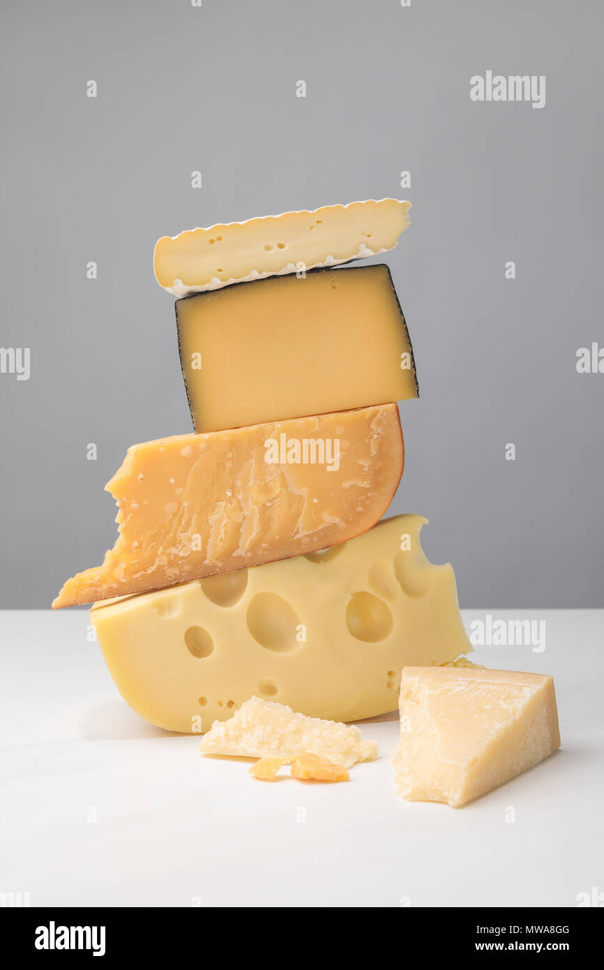 Close up view of stack of different types of cheese on gray Stock Photo ...