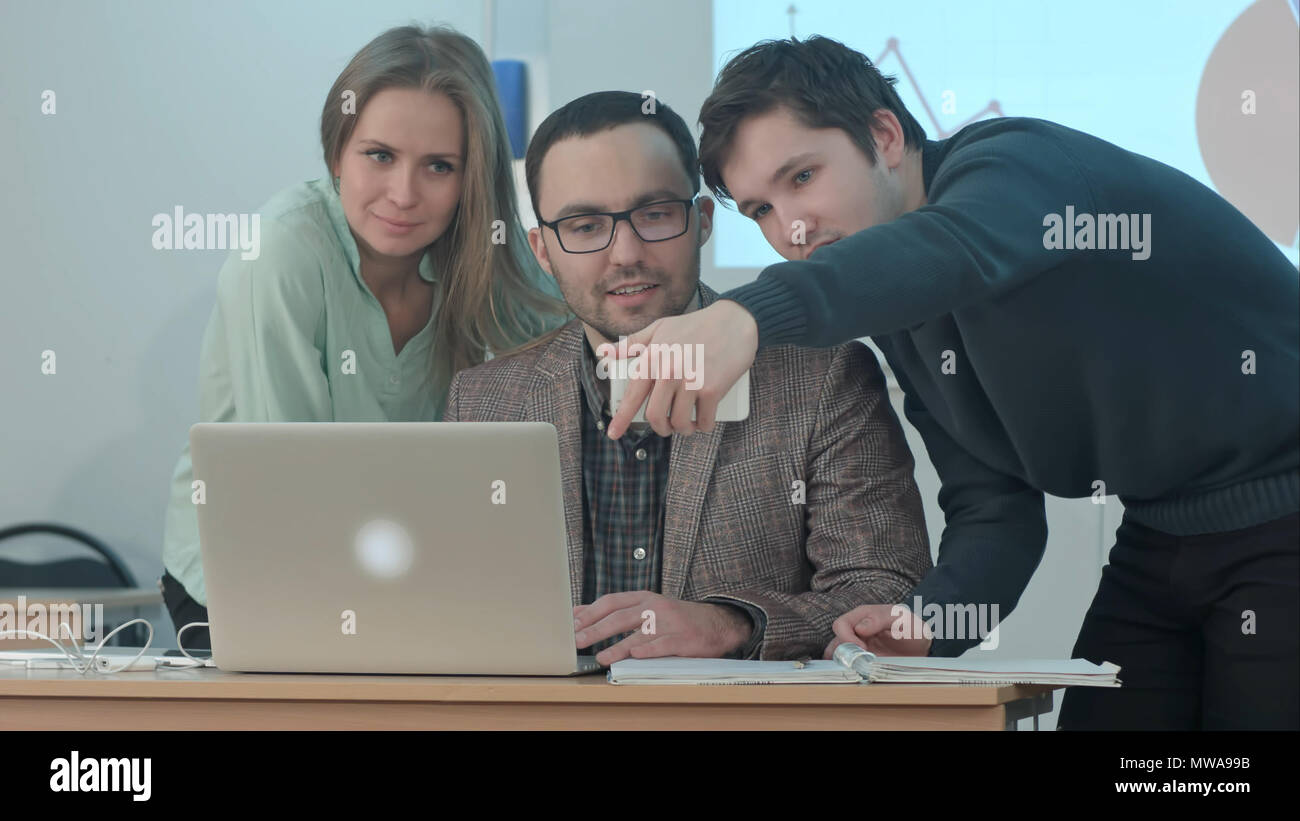 Students taking a selfie with their teacher in classroom during a break ...